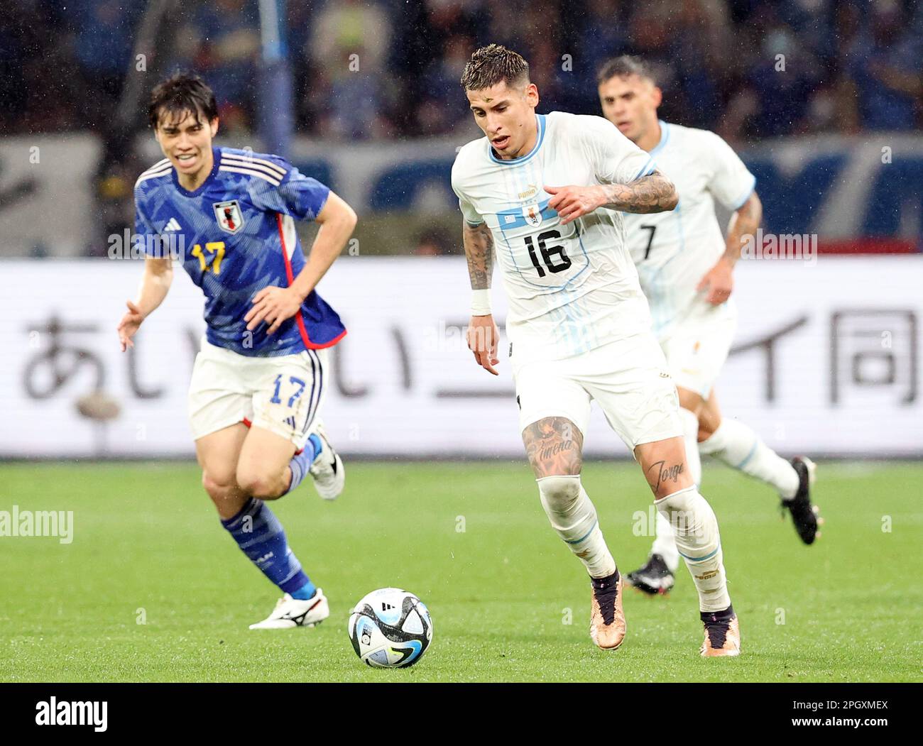 Tokyo, Japan. 24th Mar, 2023. Uruguay's Mathias Olivera (R) fights the ...