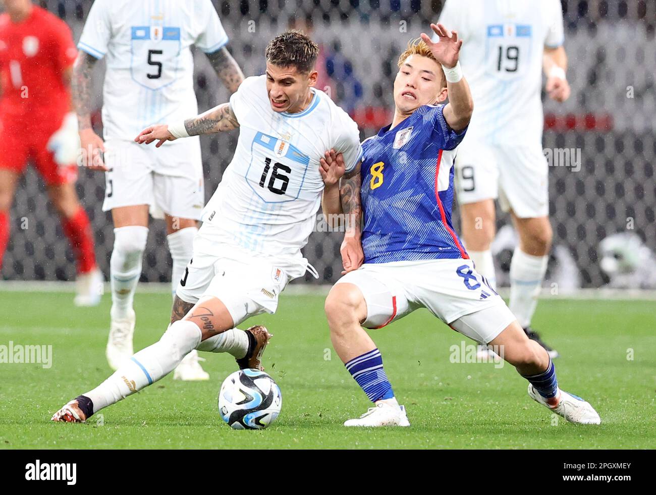 Tokyo, Japan. 24th Mar, 2023. Uruguay's Mathias Olivera (L) fights the ...