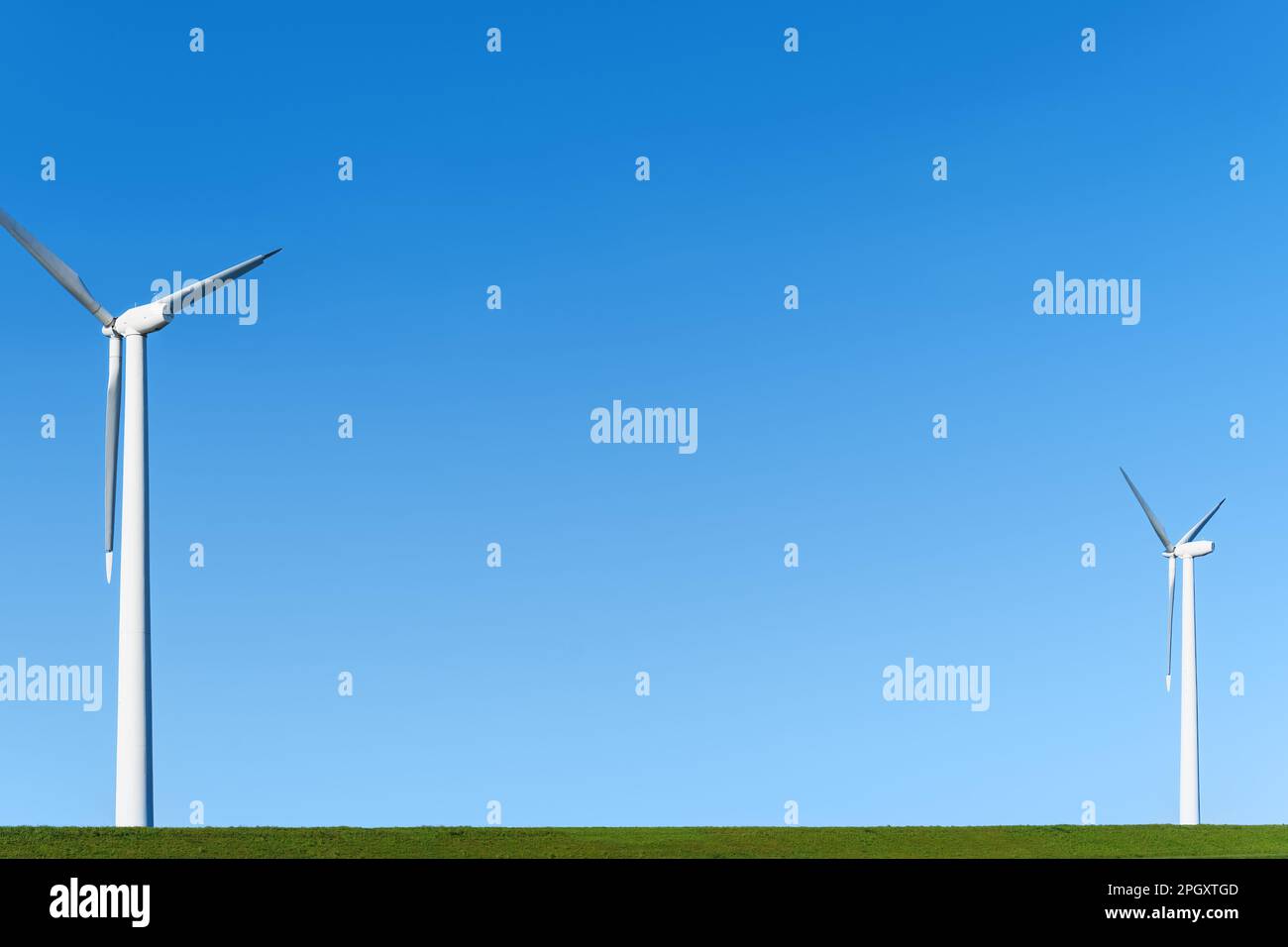 Row of wind turbines, blue sky background. Banner with many wind ...