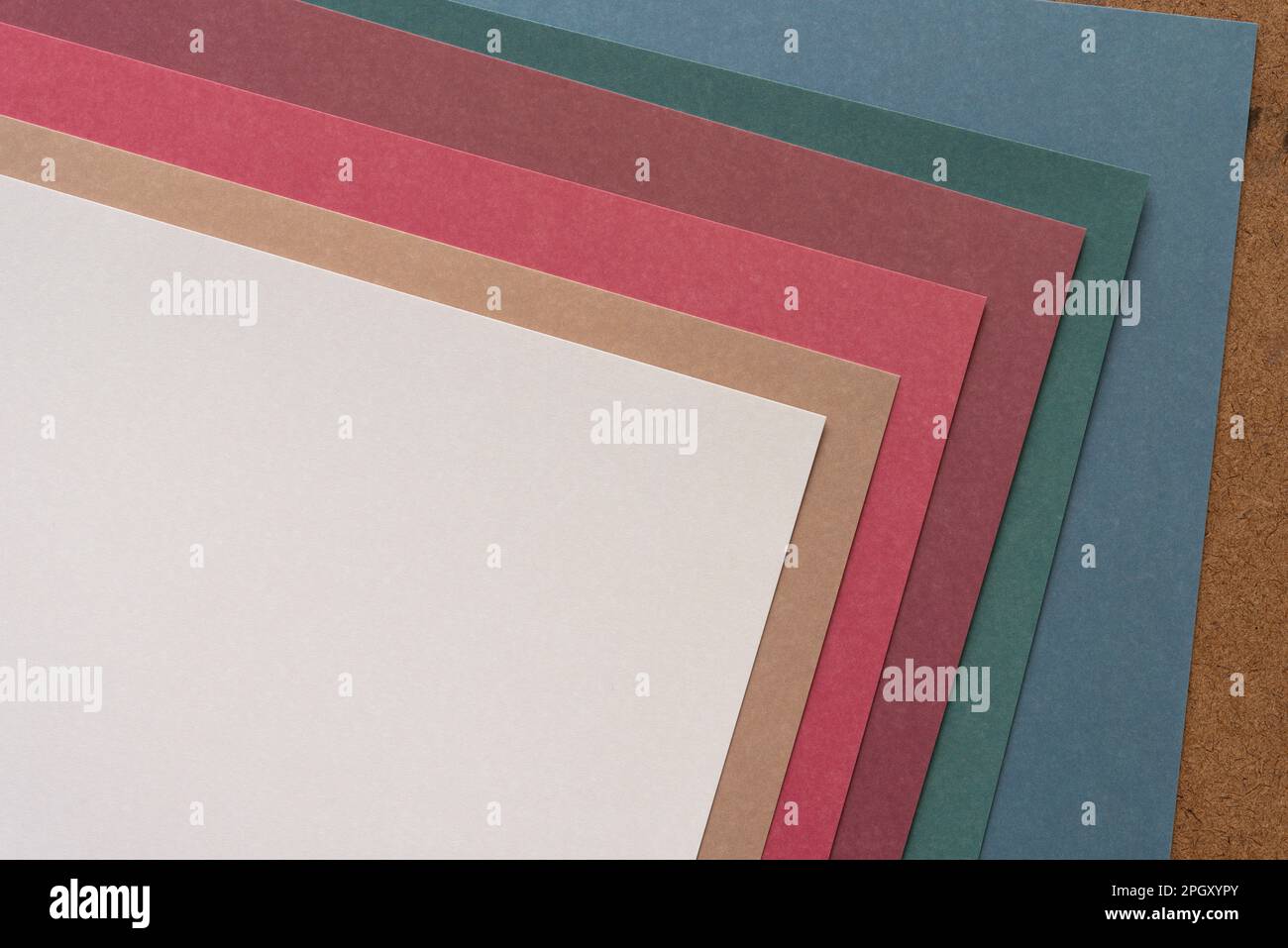 scrapbook paper background featuring layered sheets in various colours ...