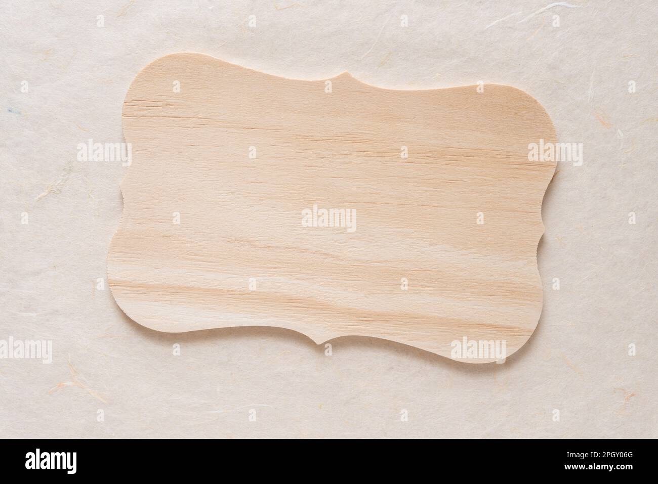 plain, untreated and unpainted crafting plaque or panel on beige tissue ...