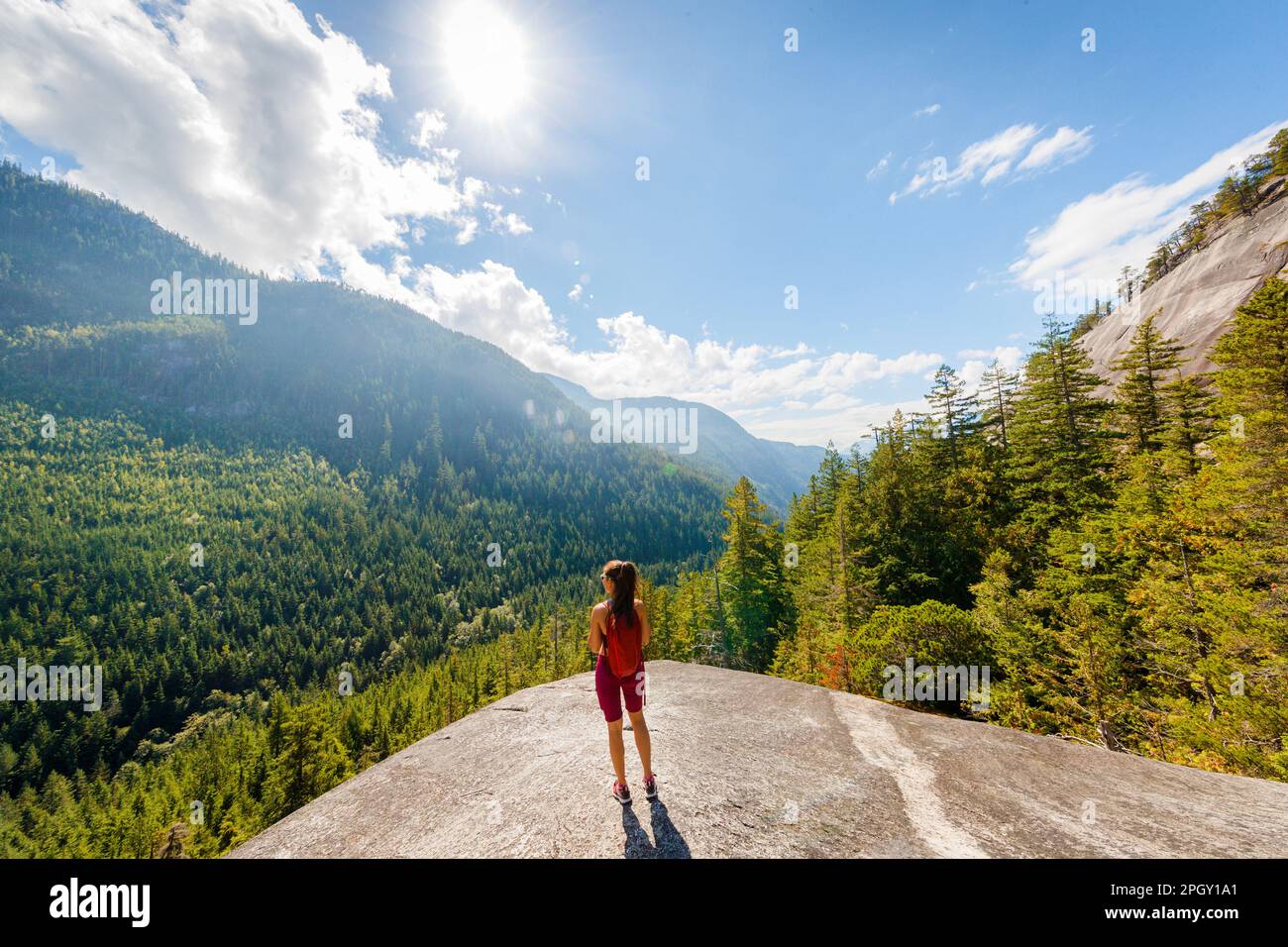 Hiking woman reaching amazing viewpoint on famous Squamish Stawamus ...