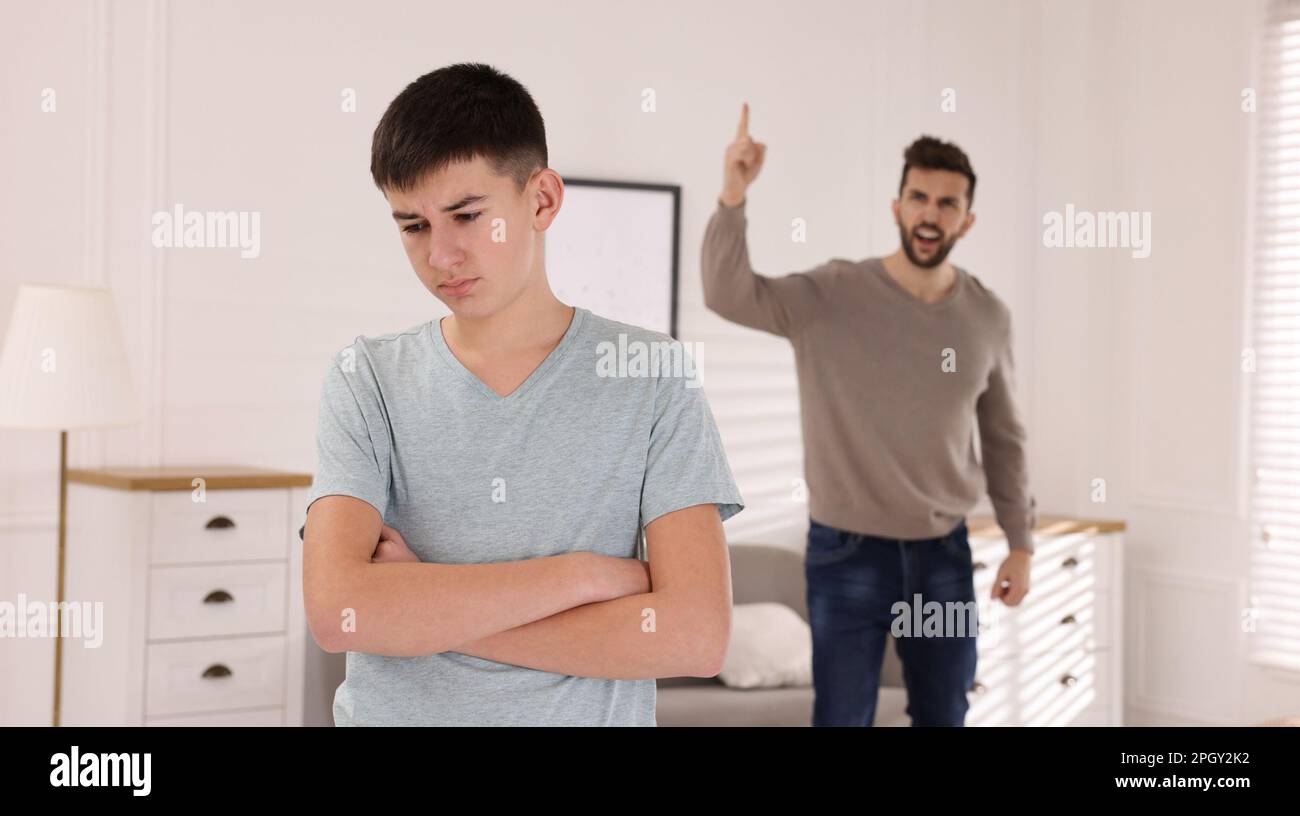 Father scolding his son at home. Teenager problems Stock Photo - Alamy