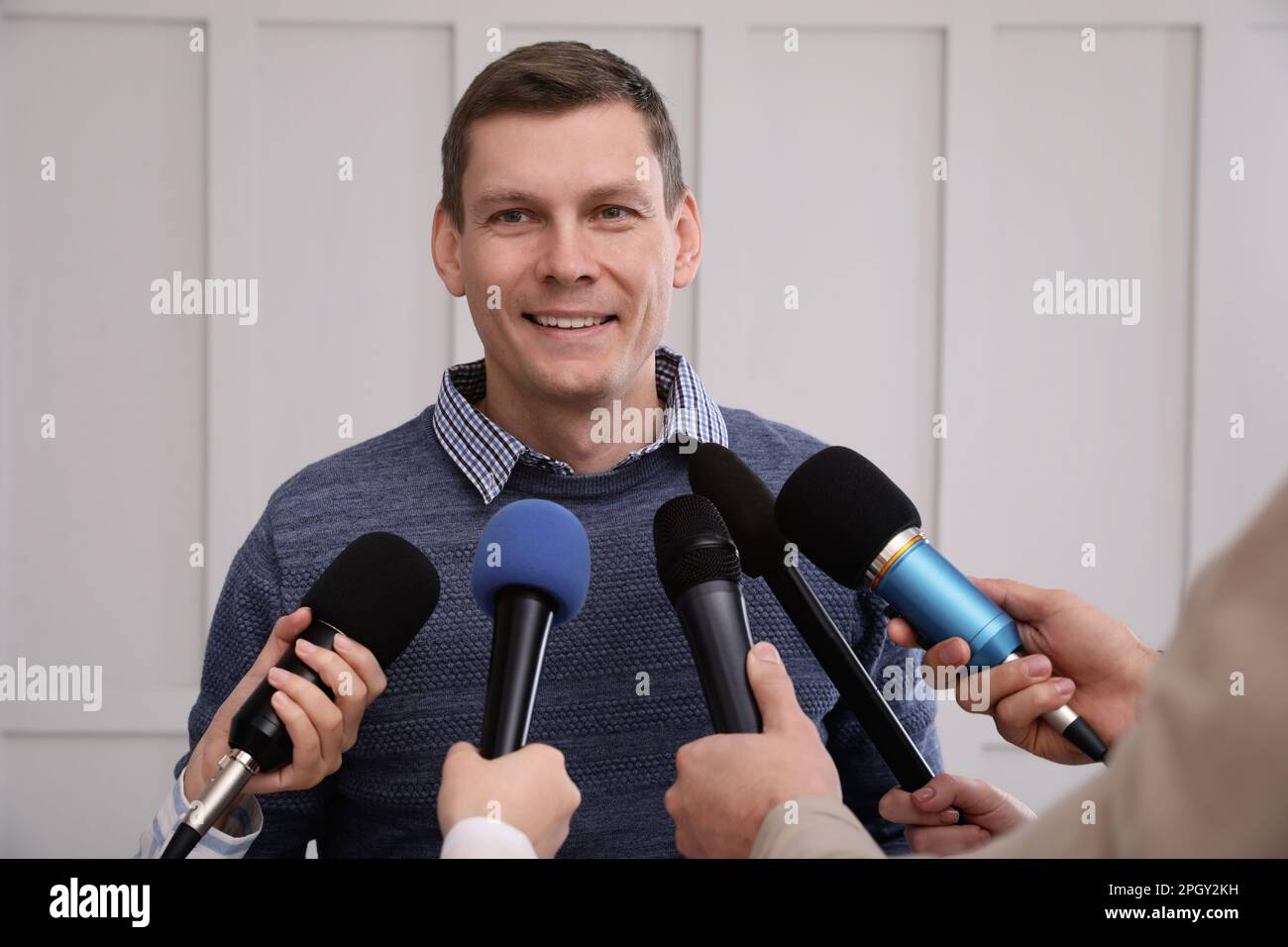 Happy business man giving interview to journalists at official event ...