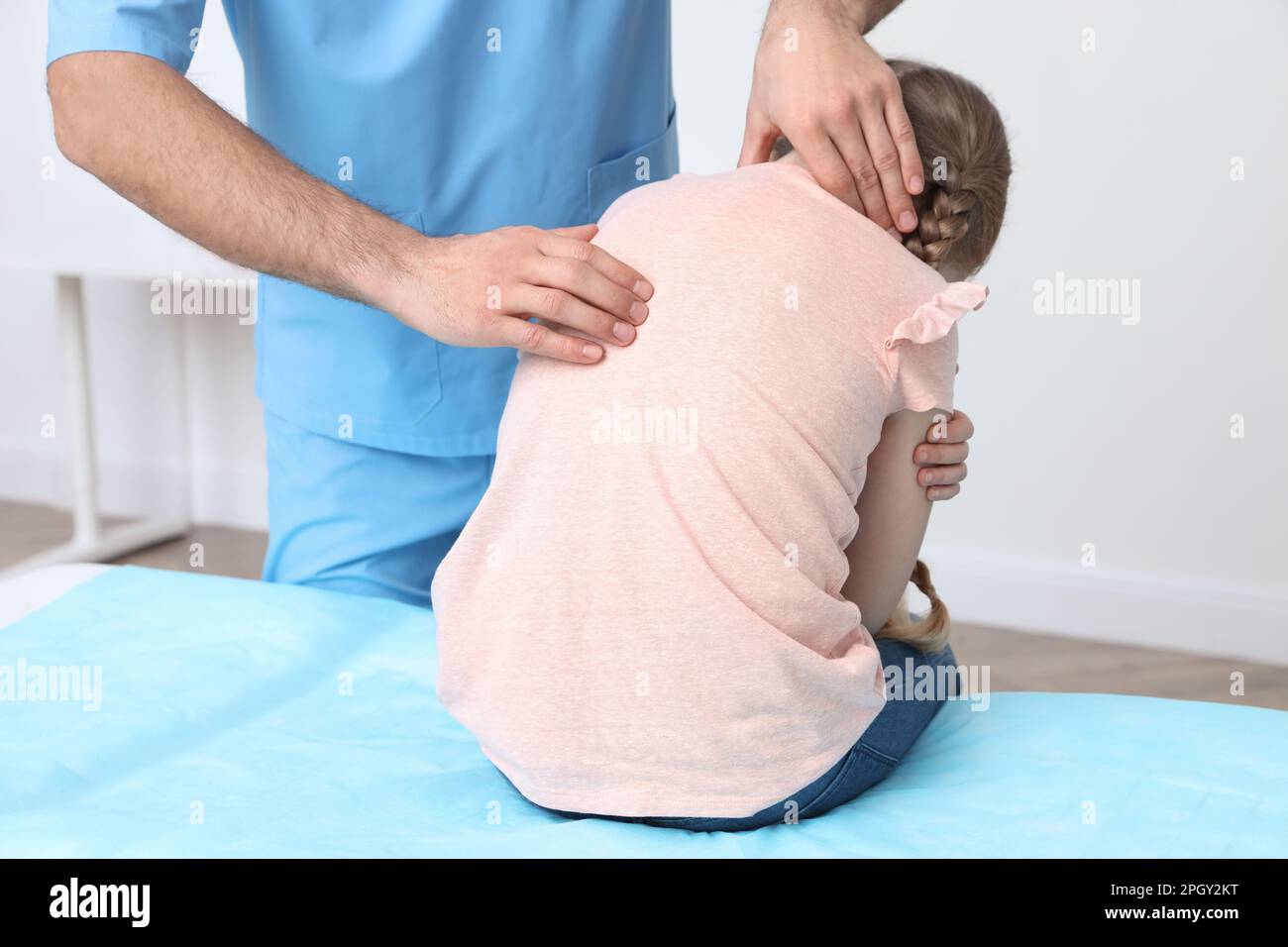 Orthopedist examining child's back in clinic, closeup. Scoliosis ...