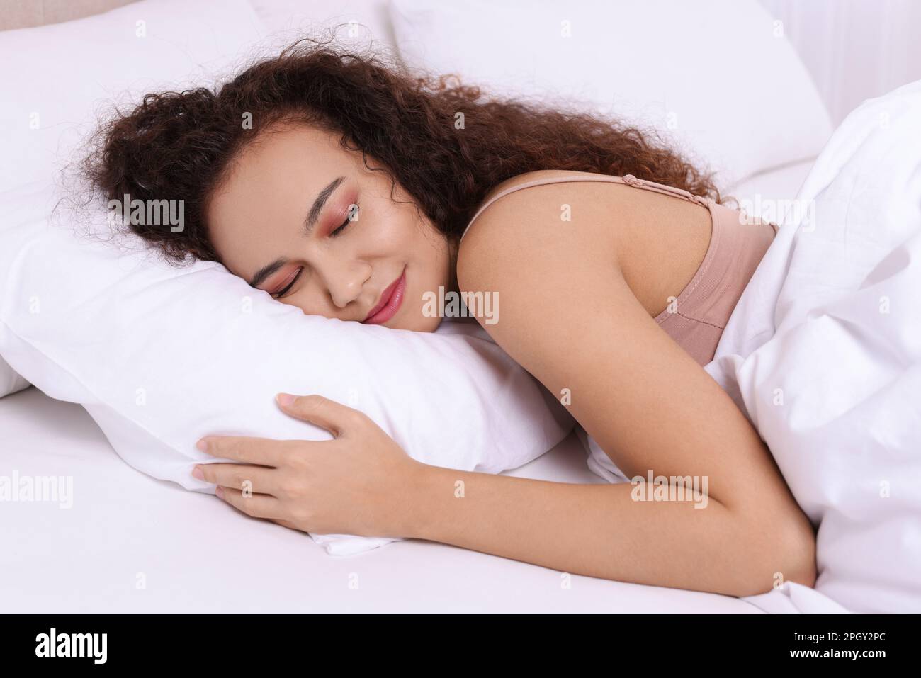 Beautiful African American woman sleeping in bed at home Stock Photo ...
