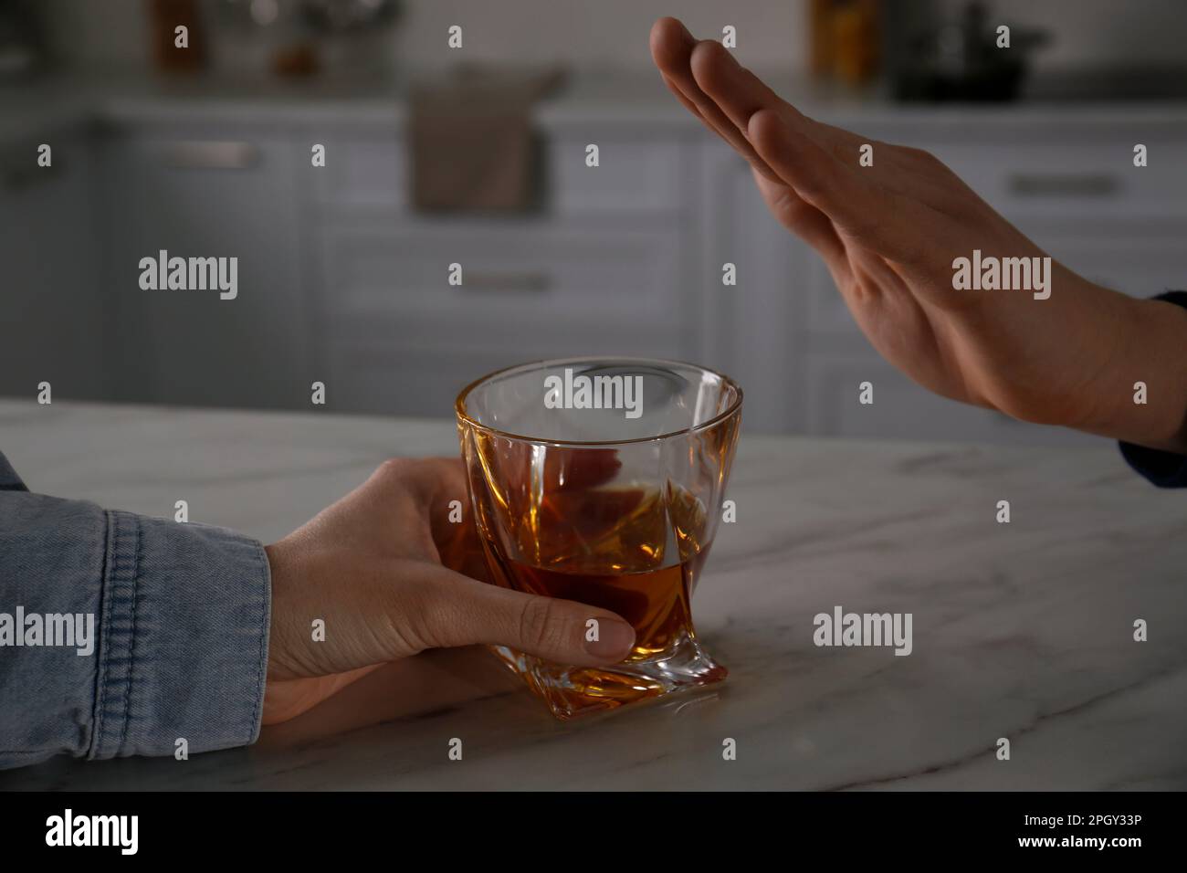 Man refusing to drink whiskey at home, closeup. Alcohol addiction ...