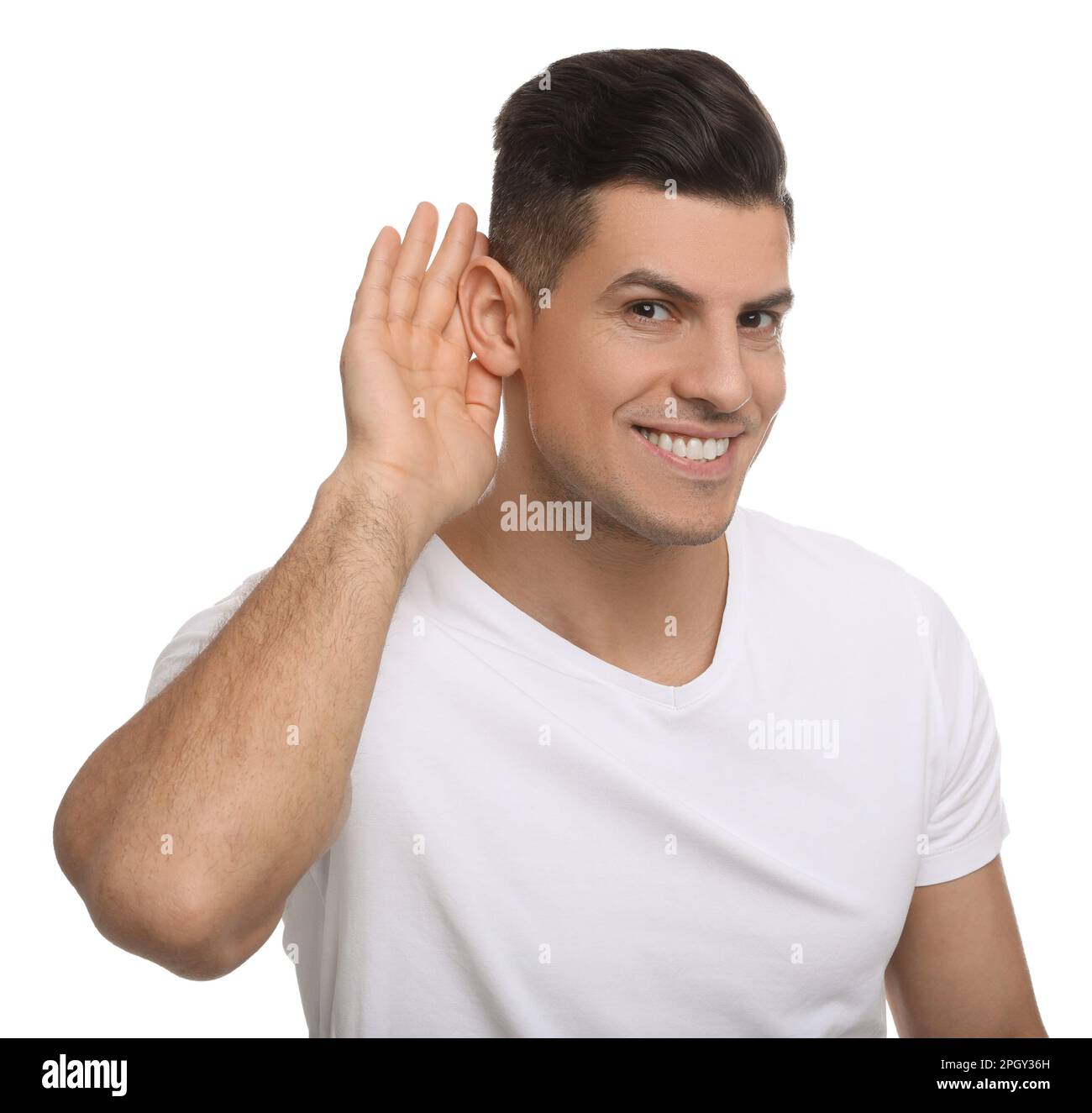 Man showing hand to ear gesture on white background Stock Photo - Alamy