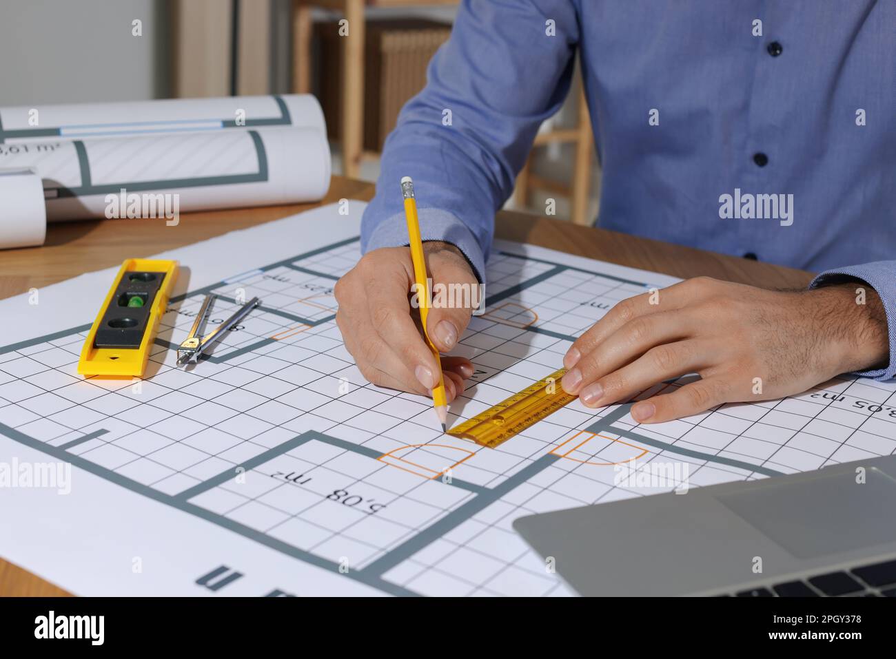 Architect working with construction drawings in office, closeup Stock ...