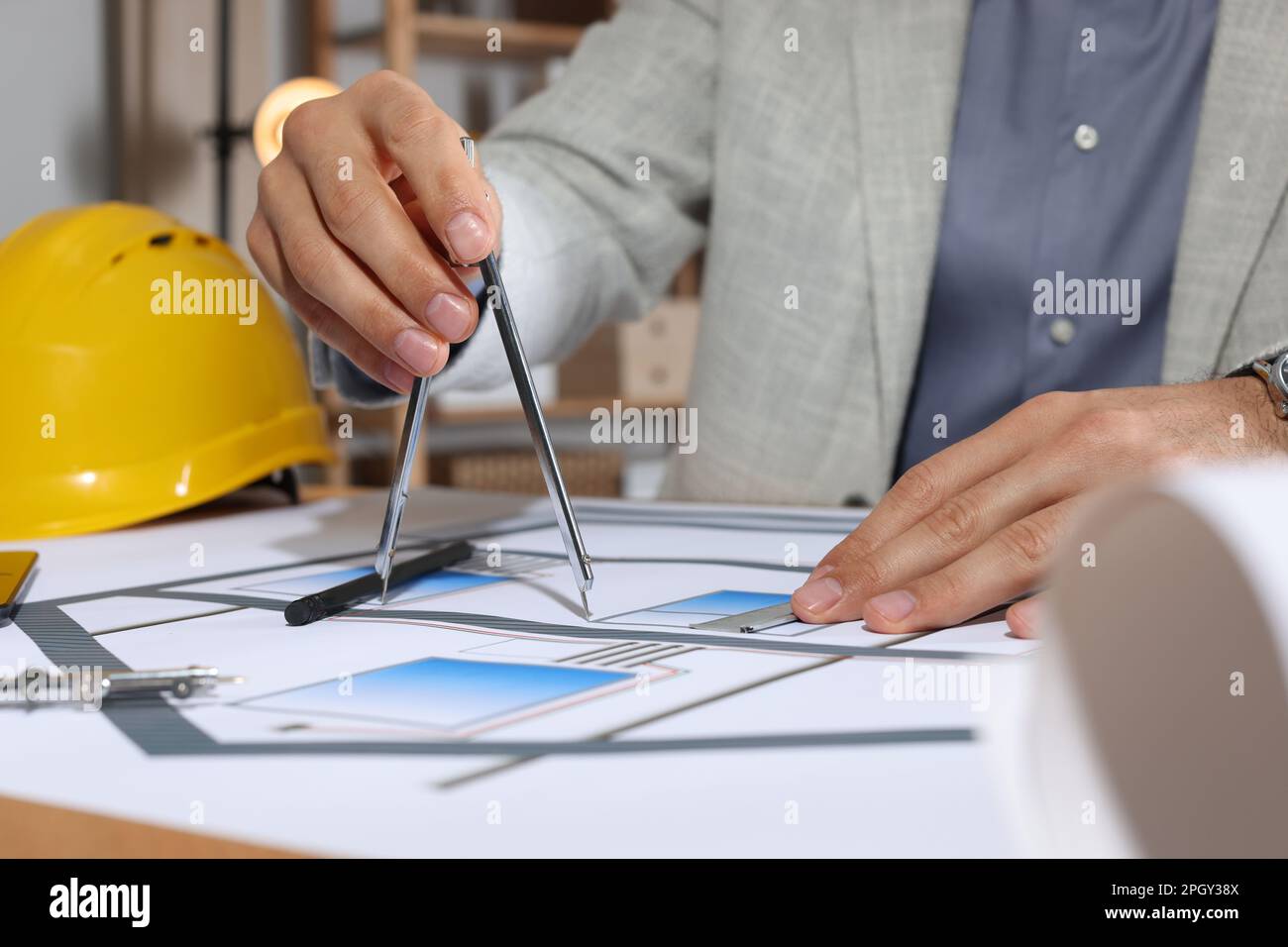 Architect working with construction drawings in office, closeup Stock Photo - Alamy