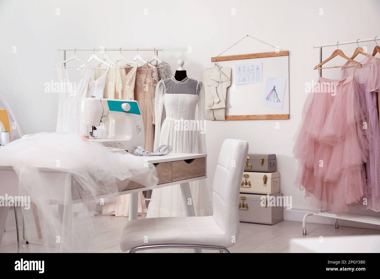 Dressmaking workshop interior with wedding dresses, female clothes and ...