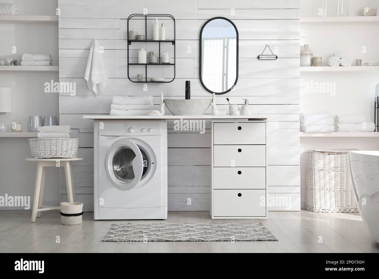 Stylish bathroom interior with modern washing machine Stock Photo - Alamy