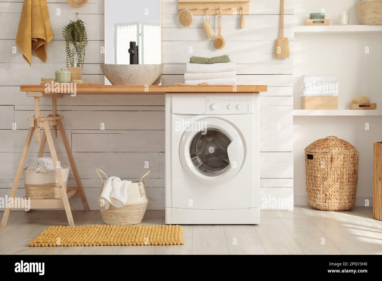 Stylish bathroom interior with modern washing machine Stock Photo - Alamy