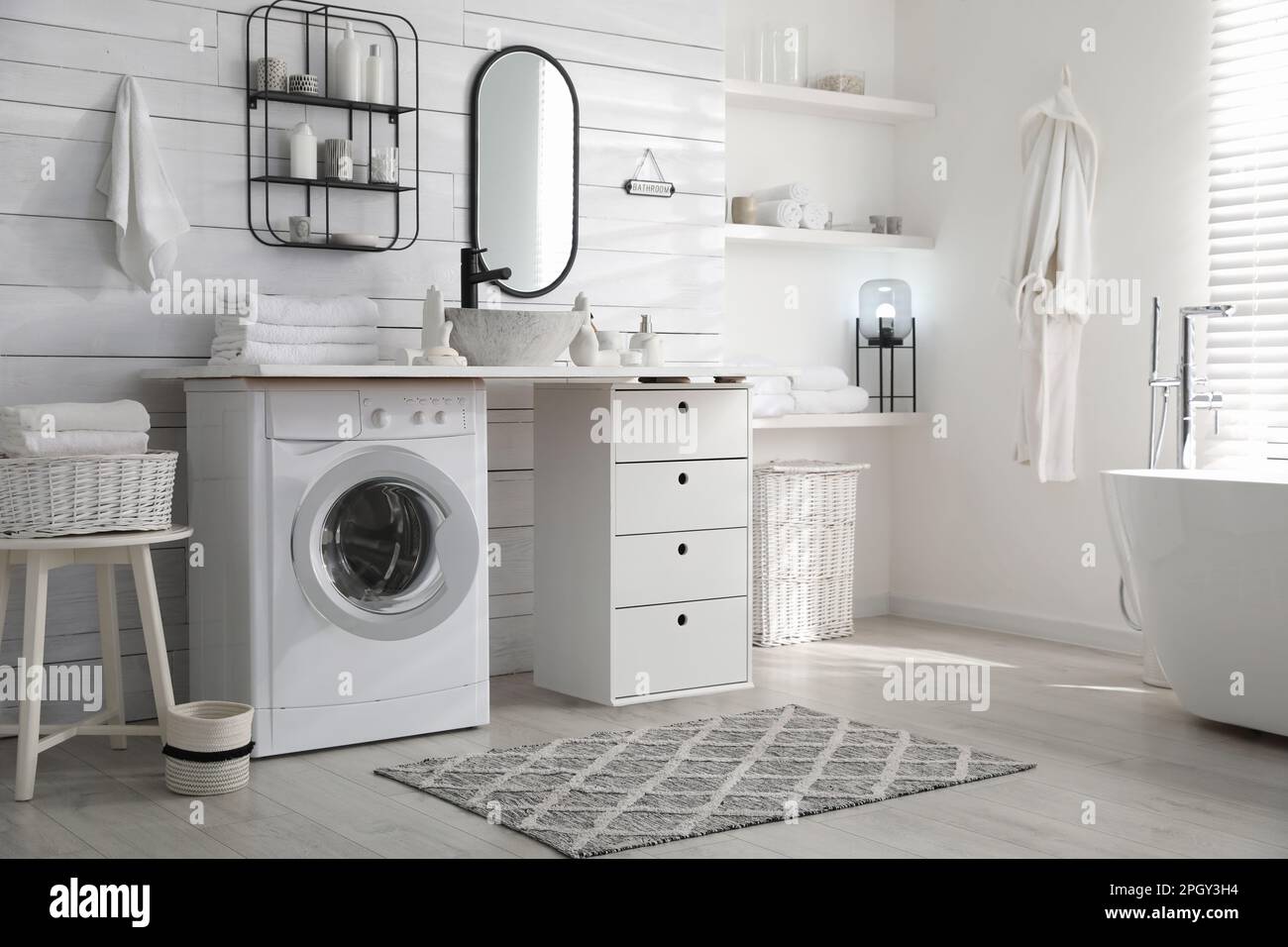 Stylish bathroom interior with modern washing machine Stock Photo - Alamy