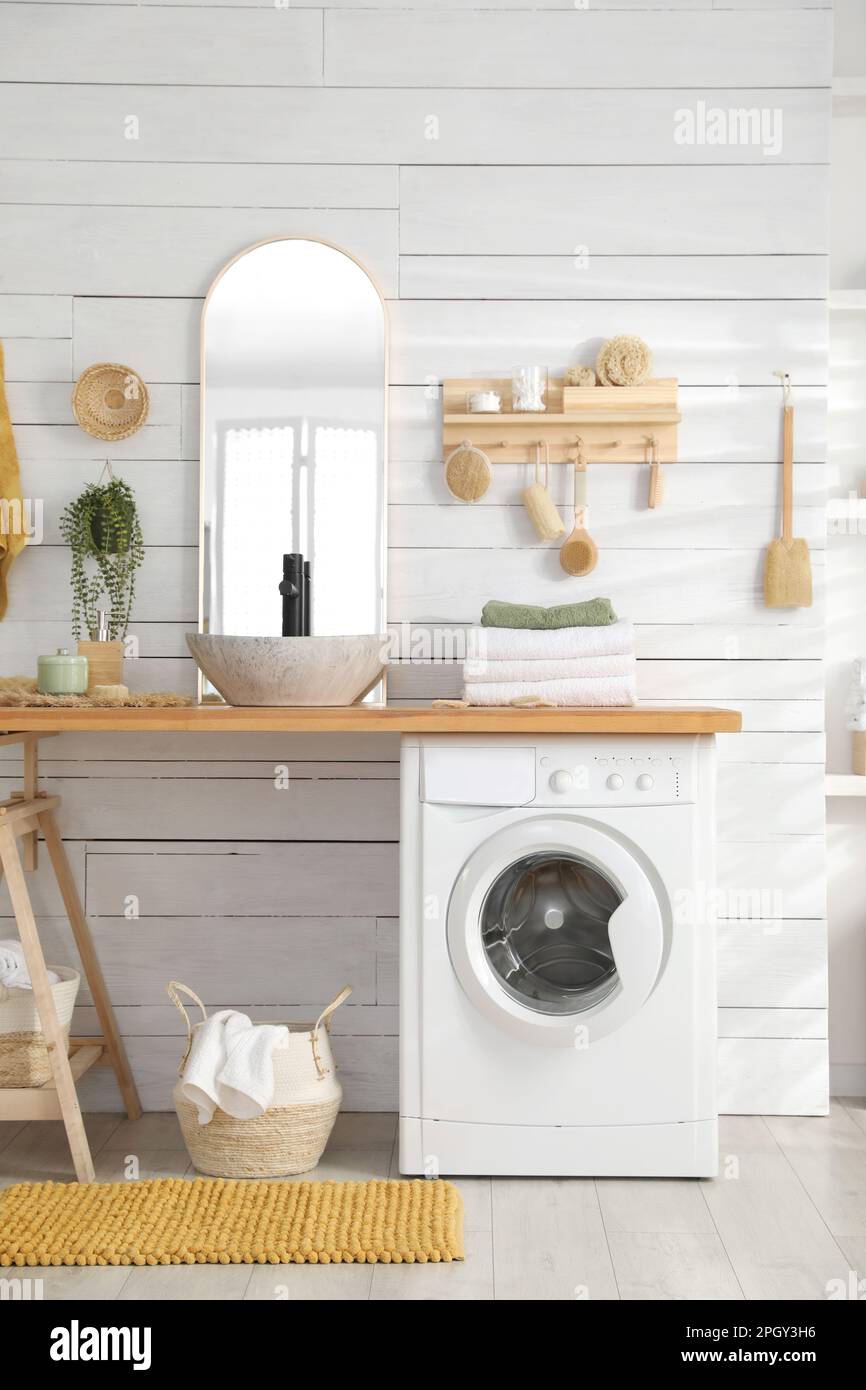 Stylish bathroom interior with modern washing machine Stock Photo - Alamy