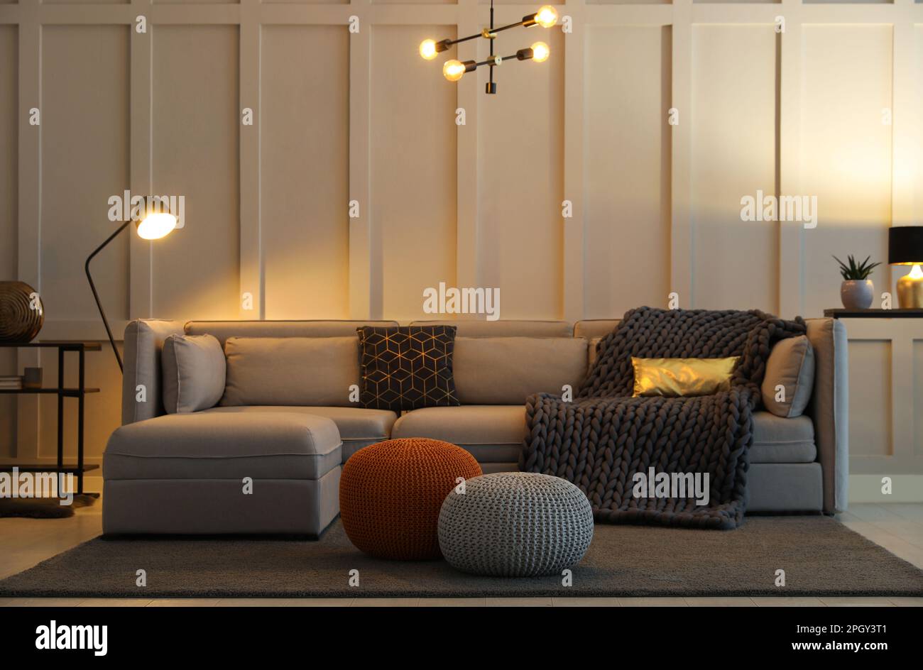 Living room interior with different stylish knitted poufs and sofa ...
