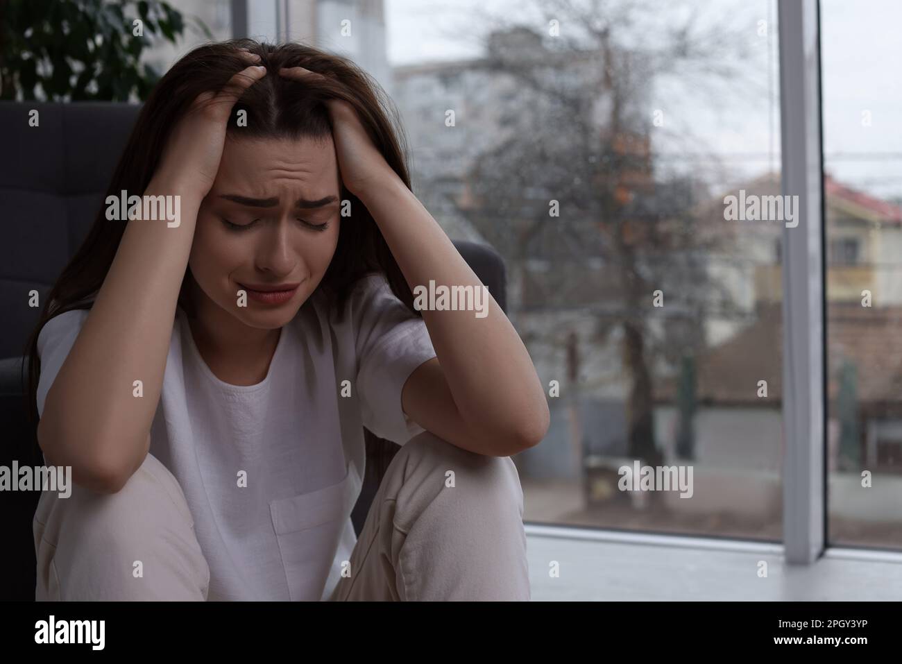 Sad young woman crying at home, space for text. Loneliness concept ...
