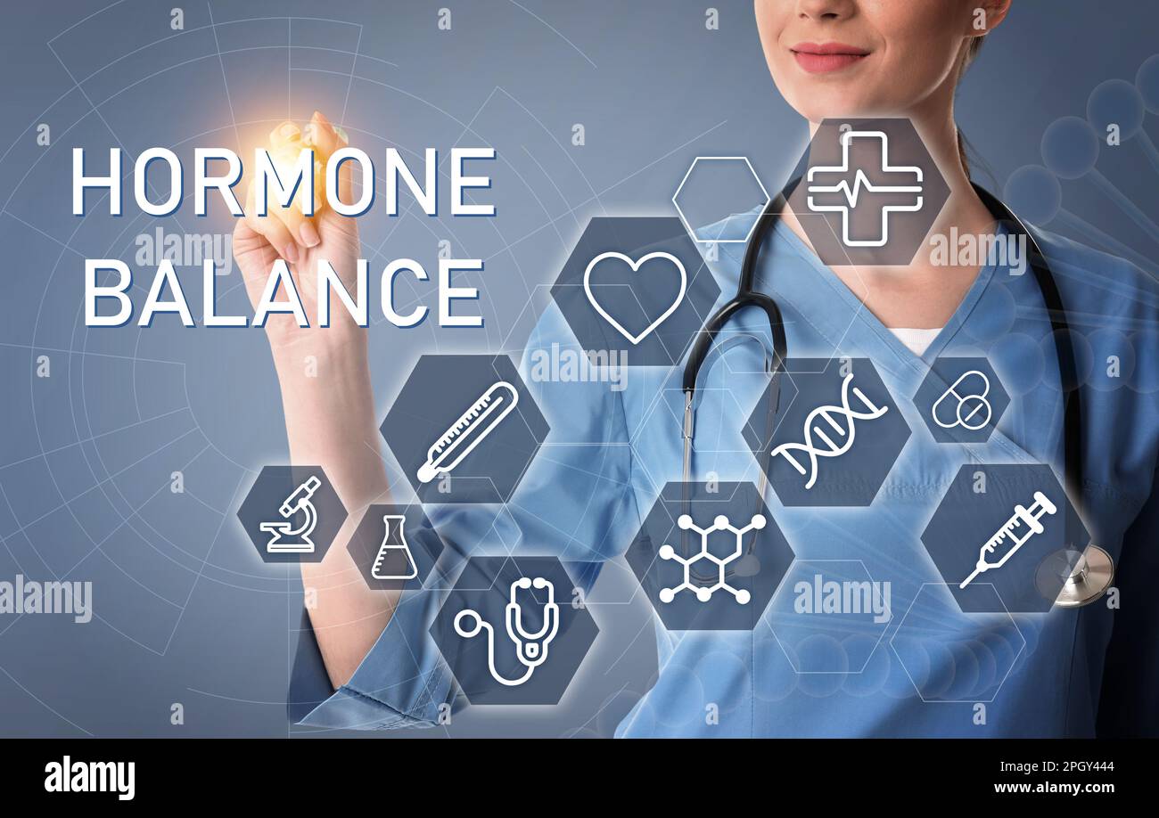 Doctor pointing at virtual screen with inscription Hormone Balance and ...