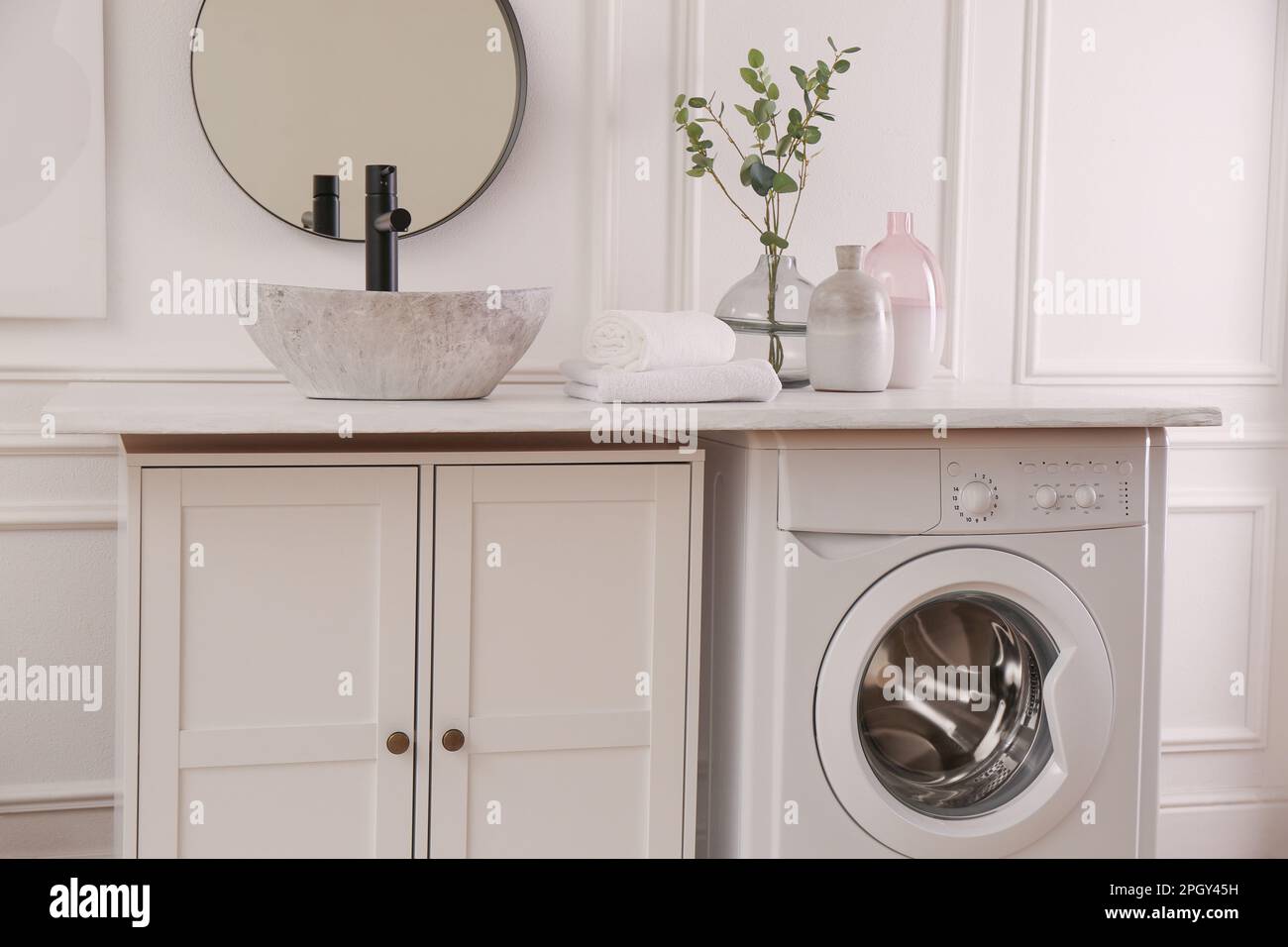 Laundry room interior with modern washing machine and stylish vessel ...
