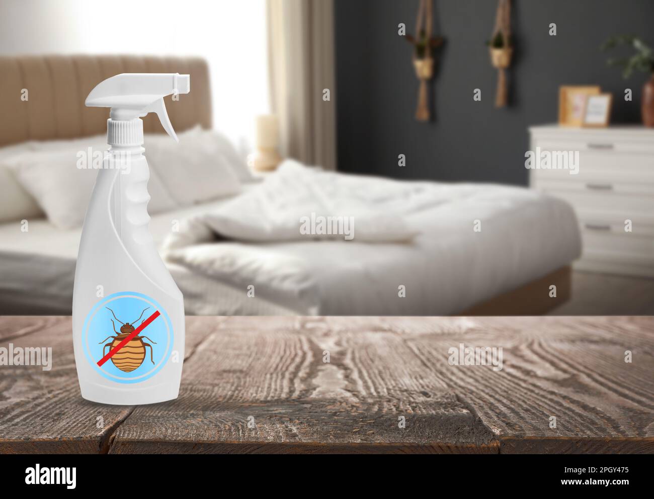 Anti bed bug spray on wooden table in bedroom. Space for text Stock ...