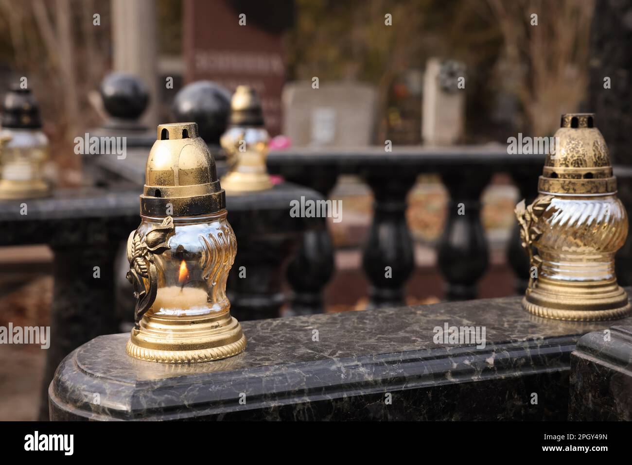 Grave lanterns on granite surface at cemetery Stock Photo - Alamy