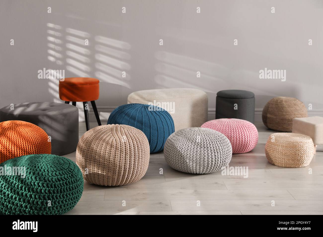 Many stylish different poufs indoors. Home design Stock Photo - Alamy