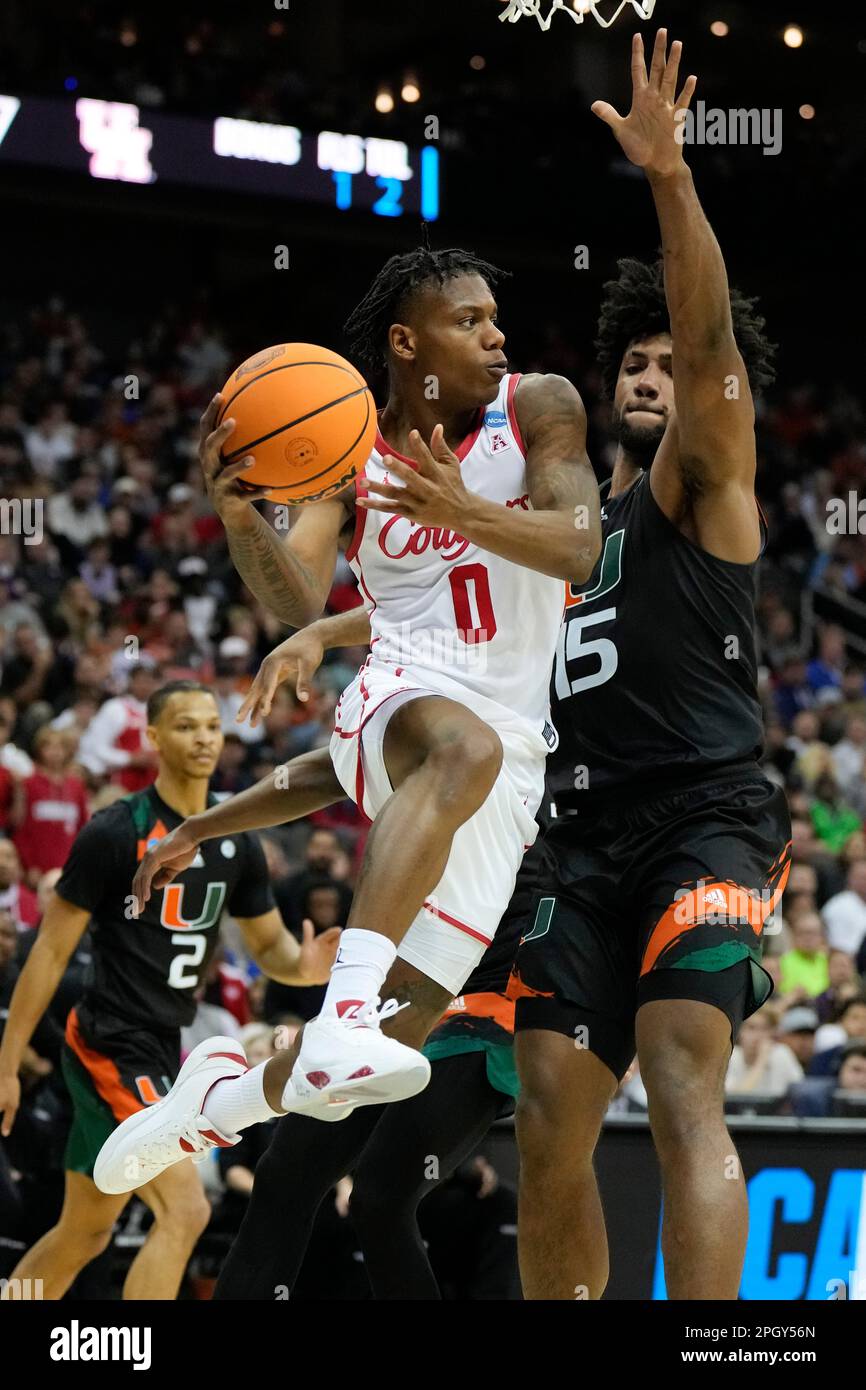 Houston guard Marcus Sasser passes around Miami forward Norchad Omier ...