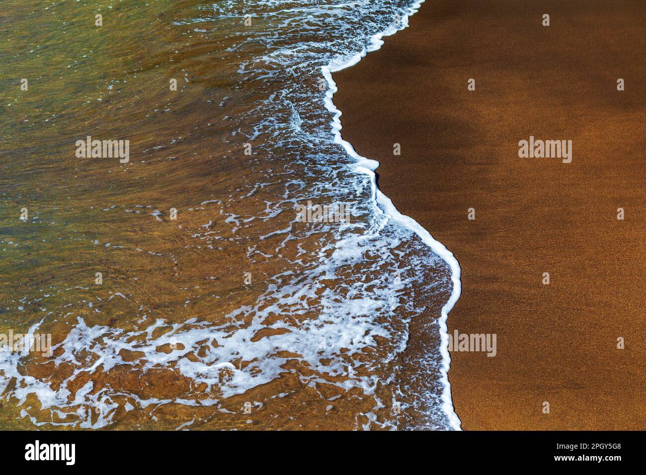 Sea wave edge . Sea foam at sandy beach Stock Photo - Alamy