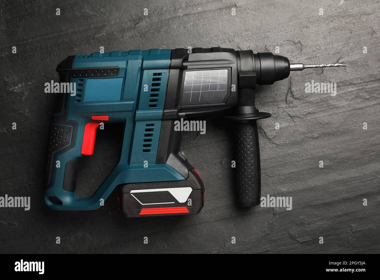 Modern electric power drill on black table, top view Stock Photo - Alamy
