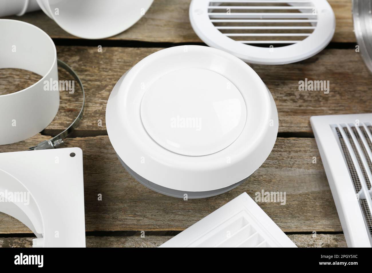 Parts of home ventilation system on wooden surface, closeup Stock Photo ...