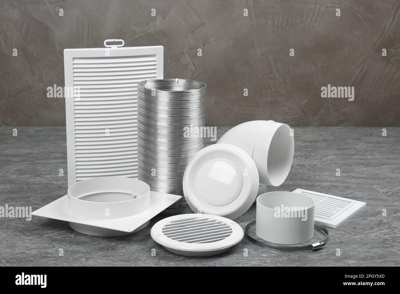 Parts of home ventilation system on grey stone surface Stock Photo - Alamy