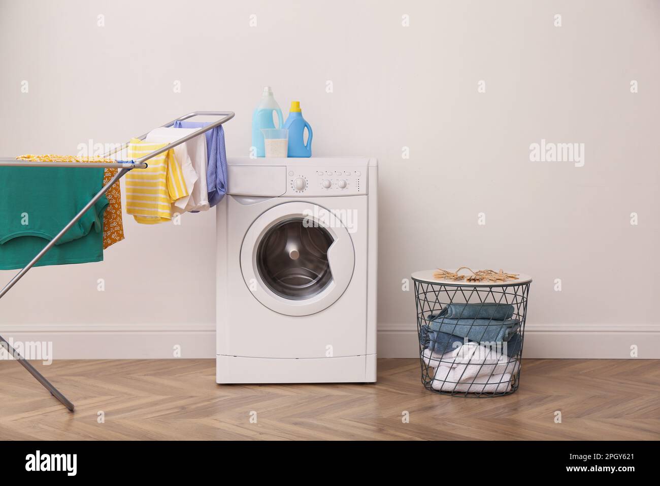 Laundry room interior with modern washing machine and drying rack Stock ...