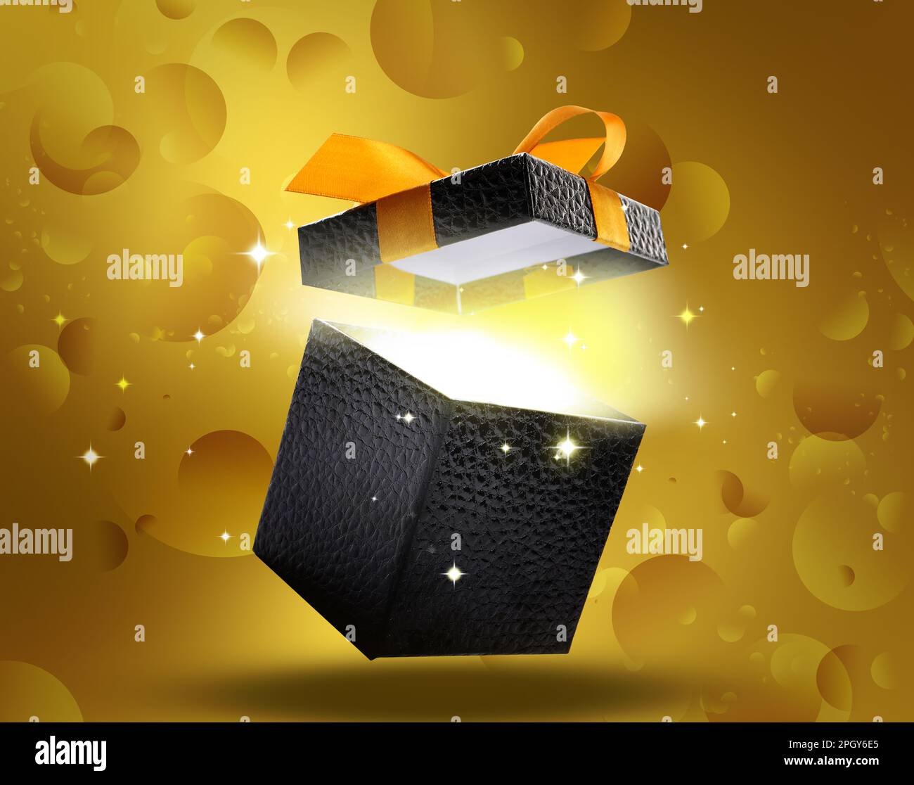 Beautiful gift box with magic light on golden background Stock Photo ...