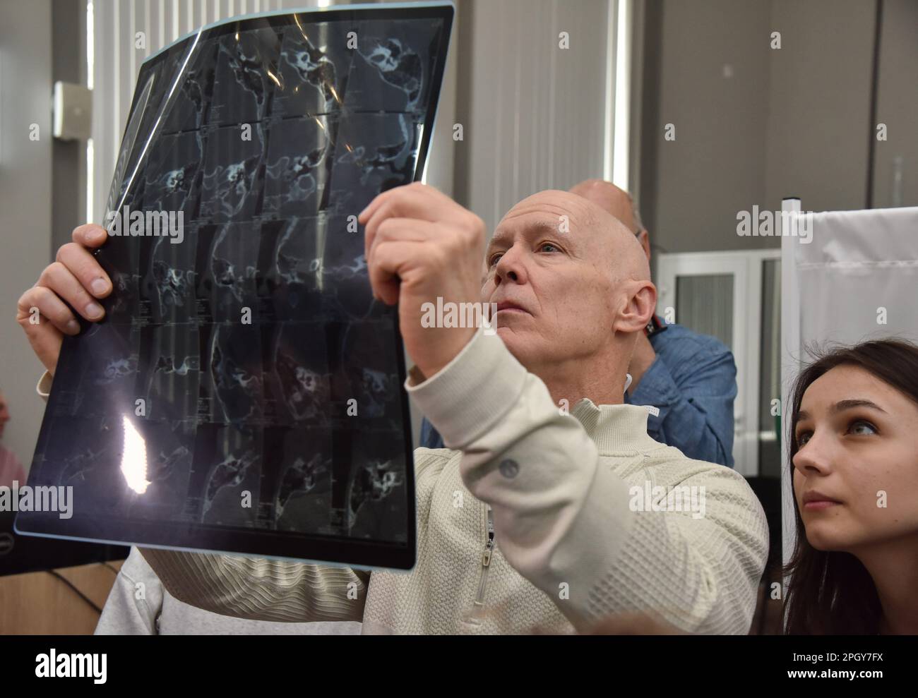 March 20, 2023, Lviv, Ukraine: An American surgeon examines an X-ray of ...