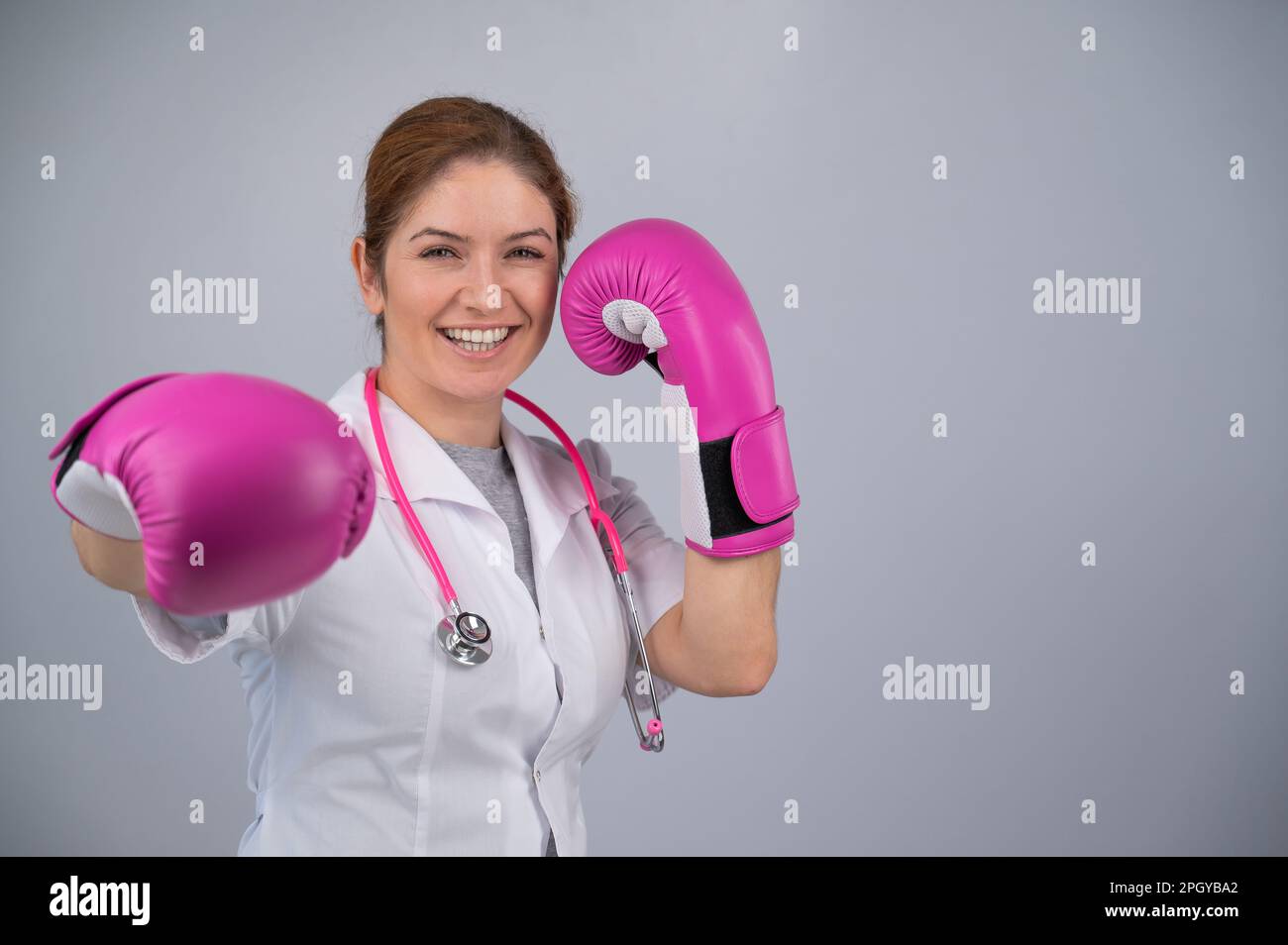 Woman doctor in pink boxing gloves on a white background Stock Photo ...