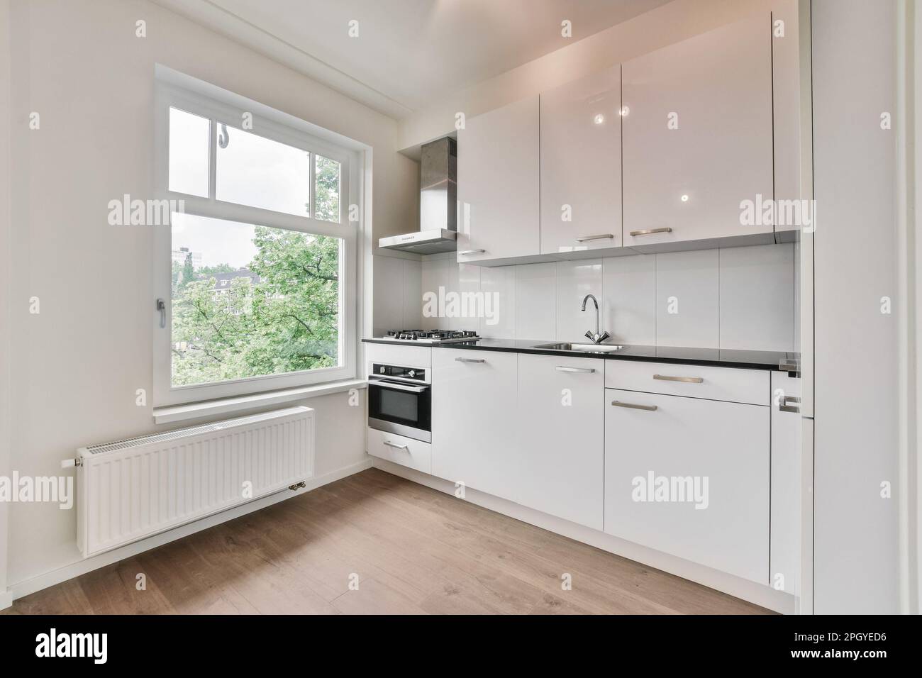 a kitchen with white cabinets and black appliances on the countertop in ...