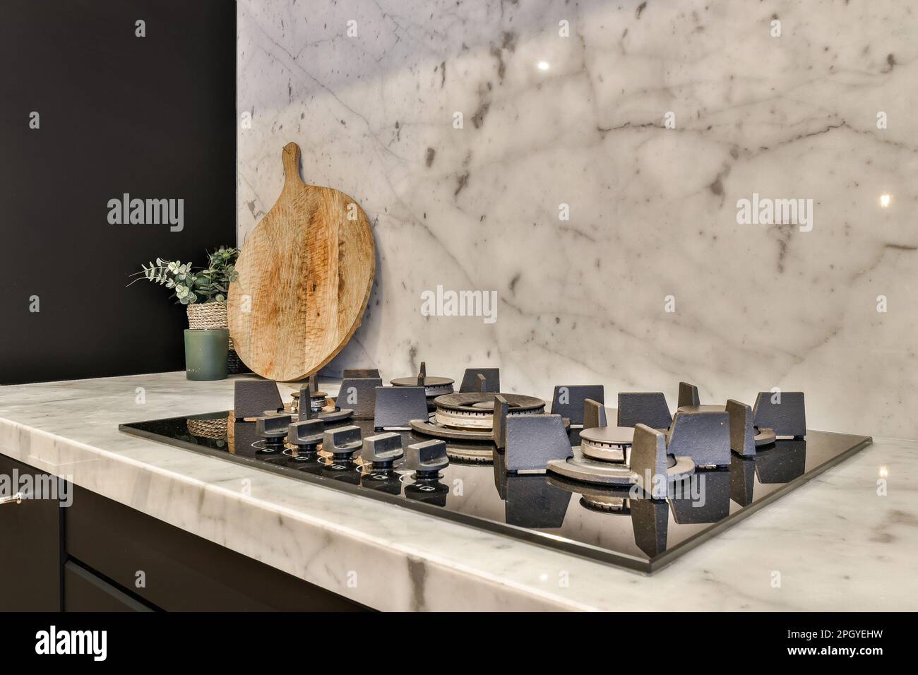 a kitchen with marble counter tops and black appliances on the stovetop ...