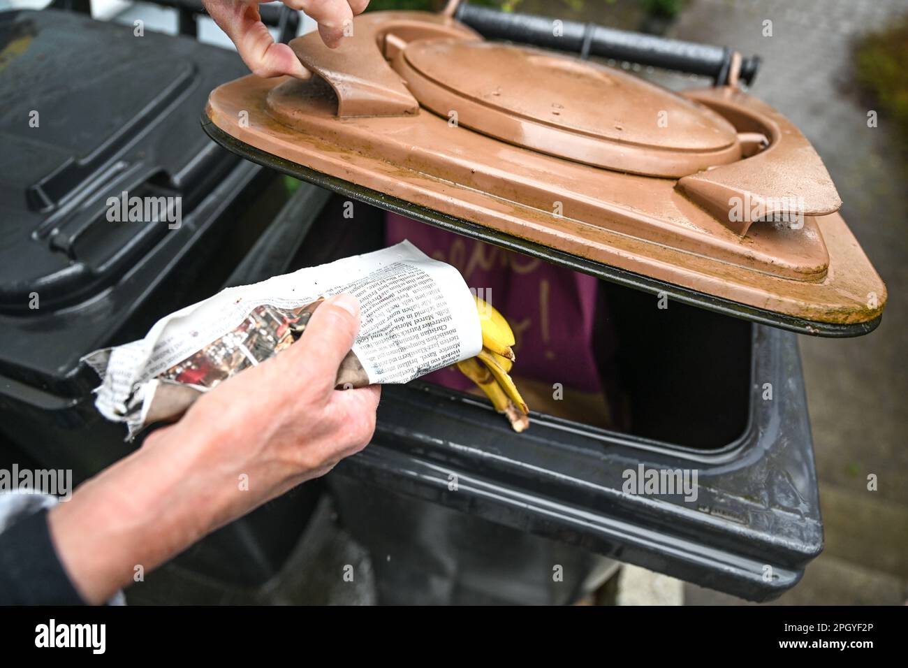 Ravensburg, Germany. 24th Mar, 2023. A woman throws banana peels ...