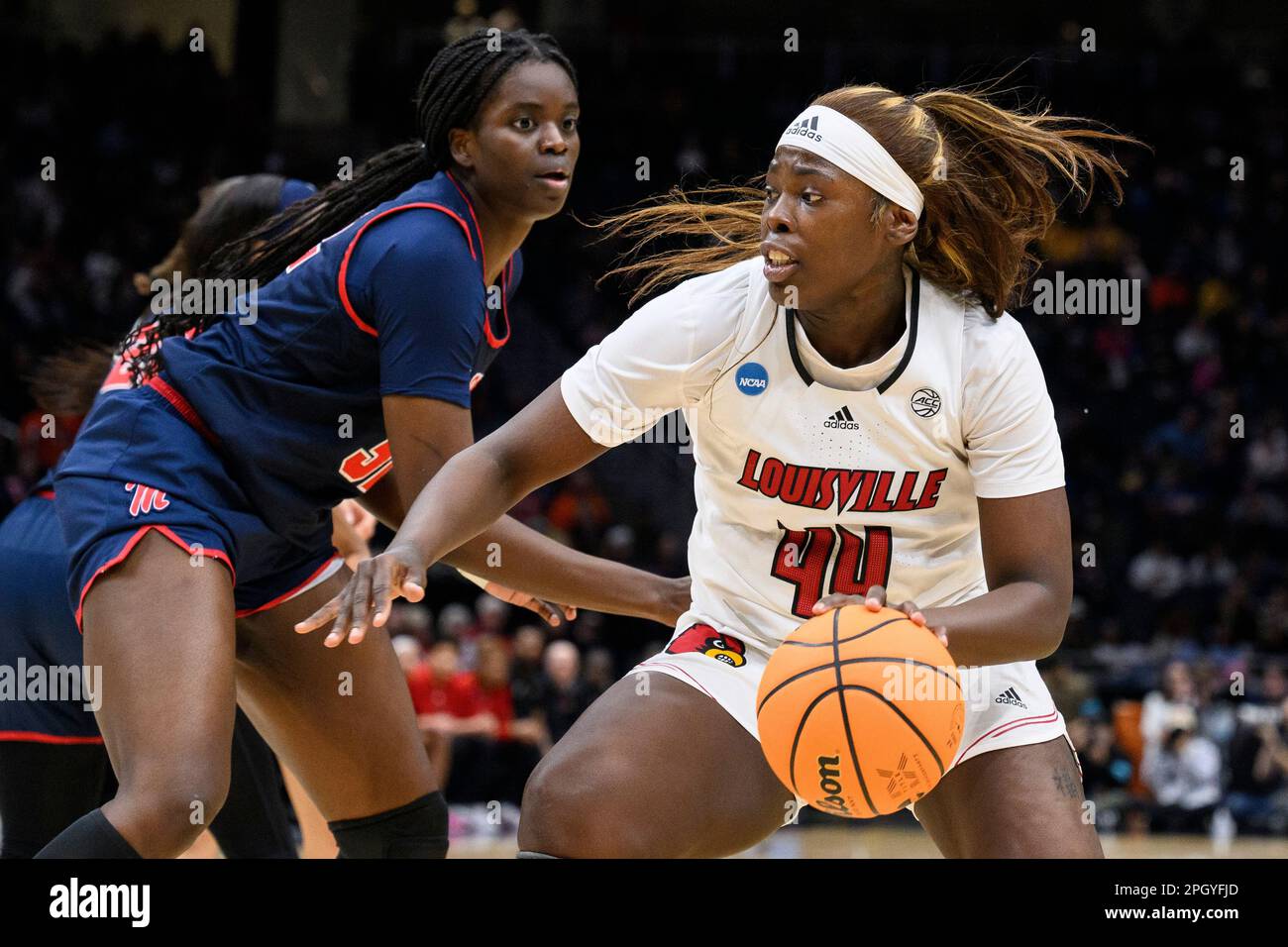 Louisville forward Olivia Cochran (44) is defended by Mississippi center Rita Igbokwe during a ...