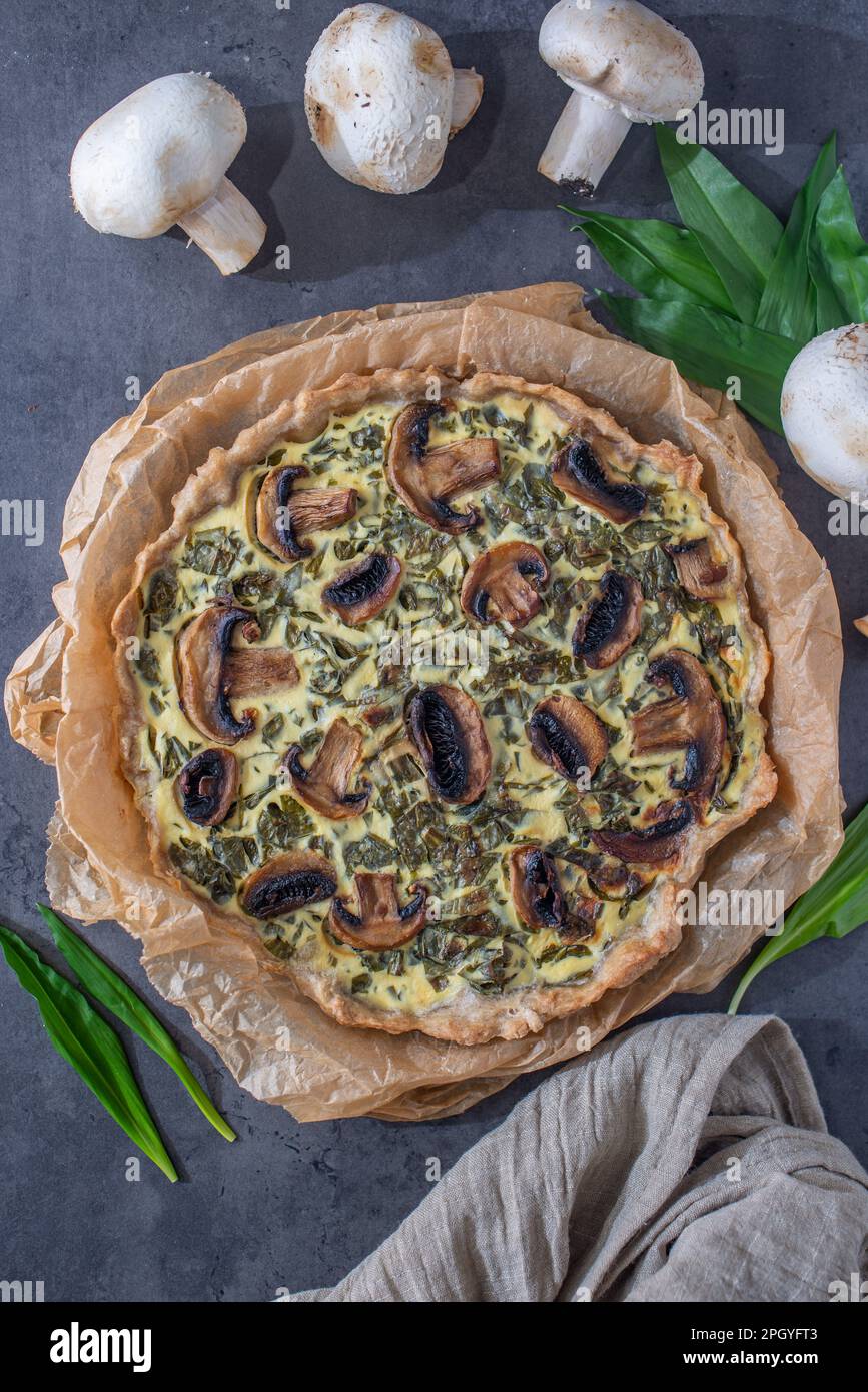 home made quiche with wild garlic on a table Stock Photo - Alamy