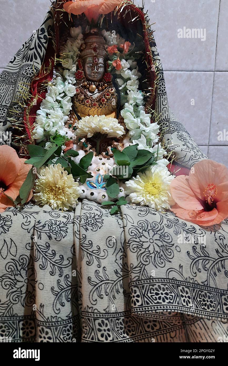 View of sari-clad idol of goddess Lakshmi decorated with flowers and ...