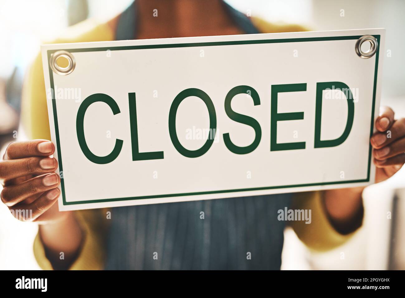 The doors are officially closed. a woman holding up a closed sign in ...