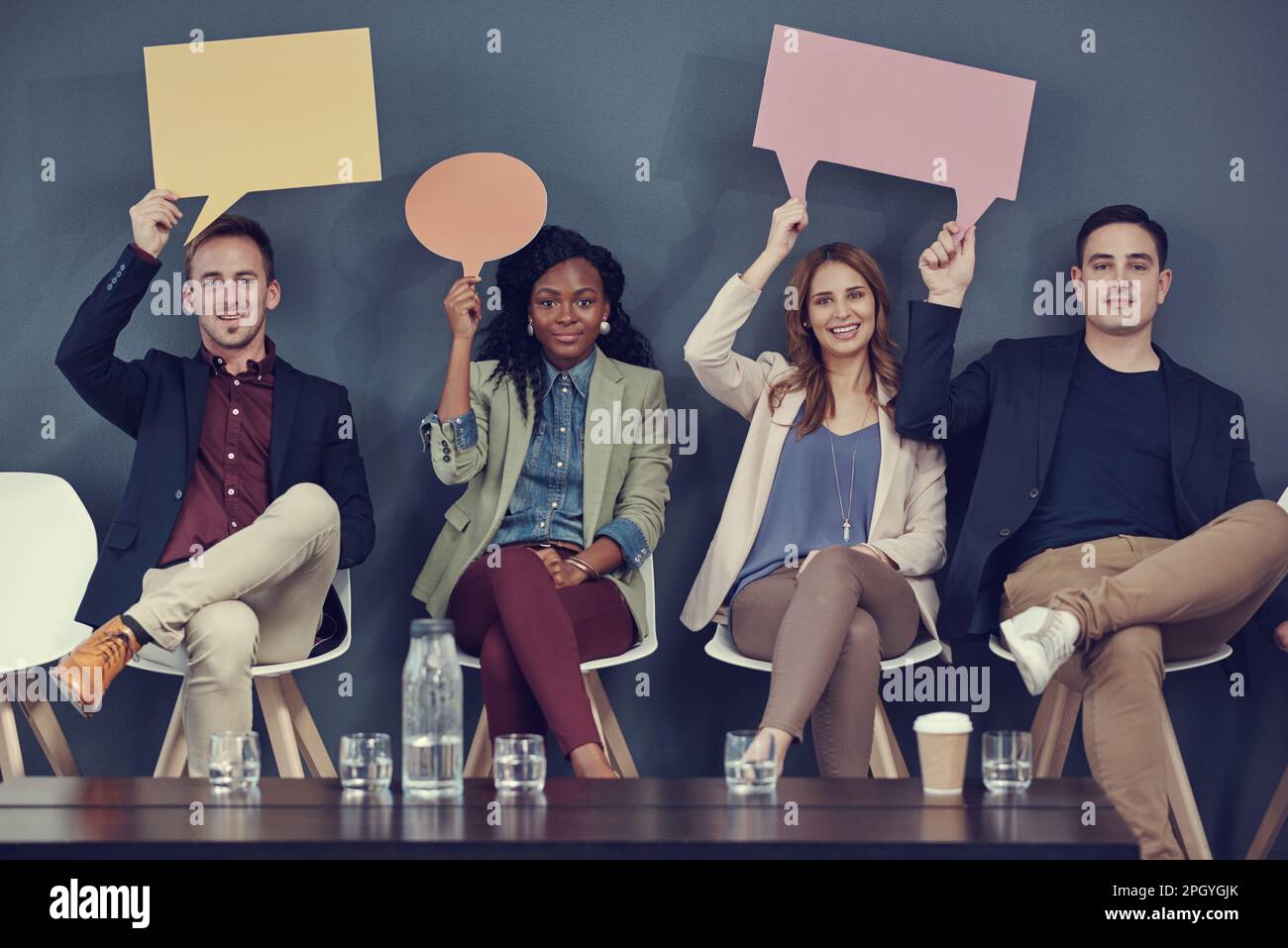 The opinionated business group. a group of businesspeople holding up ...