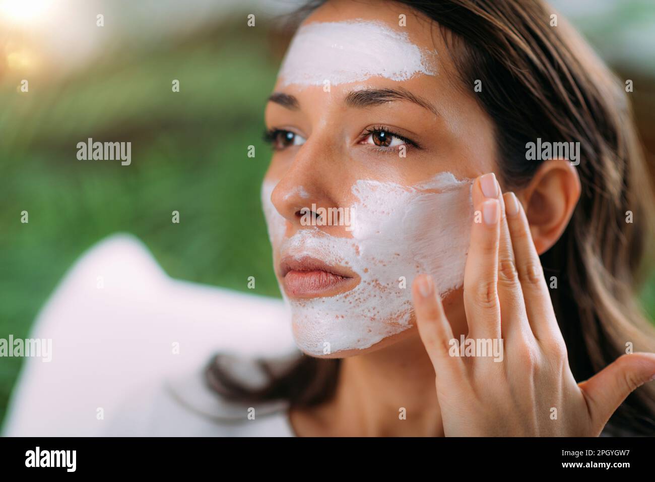 Woman applying facial cosmetic hi-res stock photography and images - Alamy