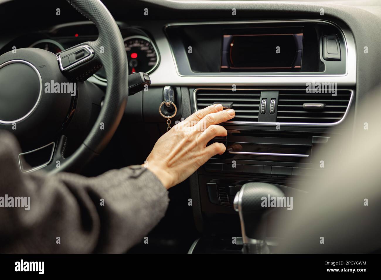 Female hand is controlling car air conditioning system grid panel on ...