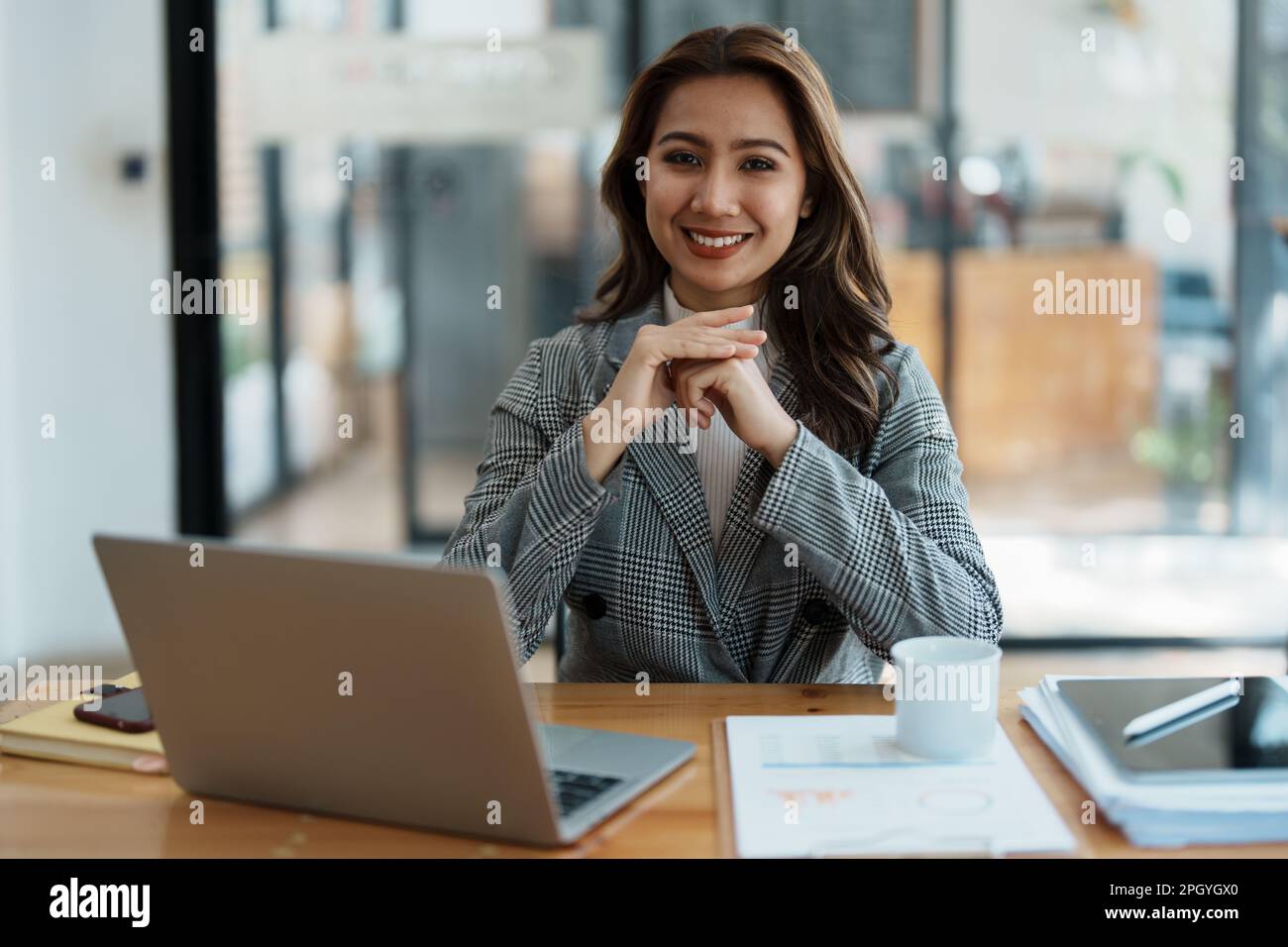 Portrait of a woman business owner showing a happy smiling face as he ...