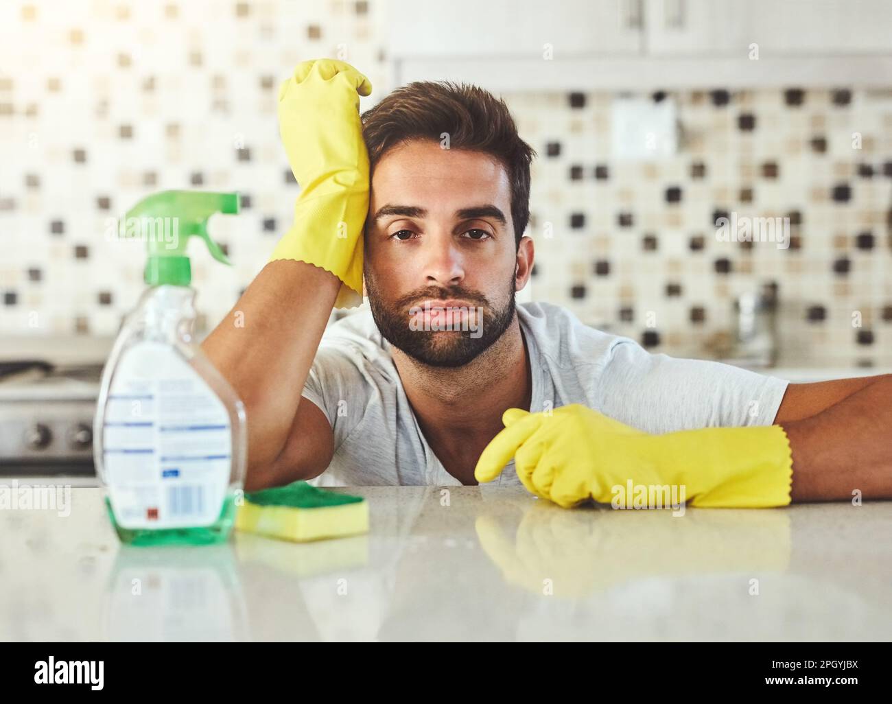 So much to clean and not enough time. Cropped portrait of a handsome ...