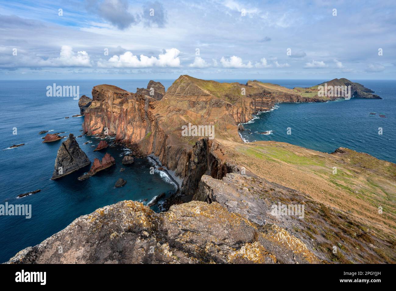 View over rocky promontory, red cliffs and rocks in the sea, coastal ...