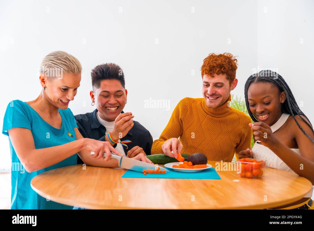 Group of friends preparing vegetarian food. They prepare food and have ...