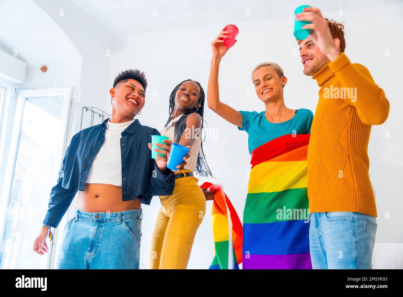 LGBT pride, lgbt rainbow flag, group of friends dancing and toasting ...